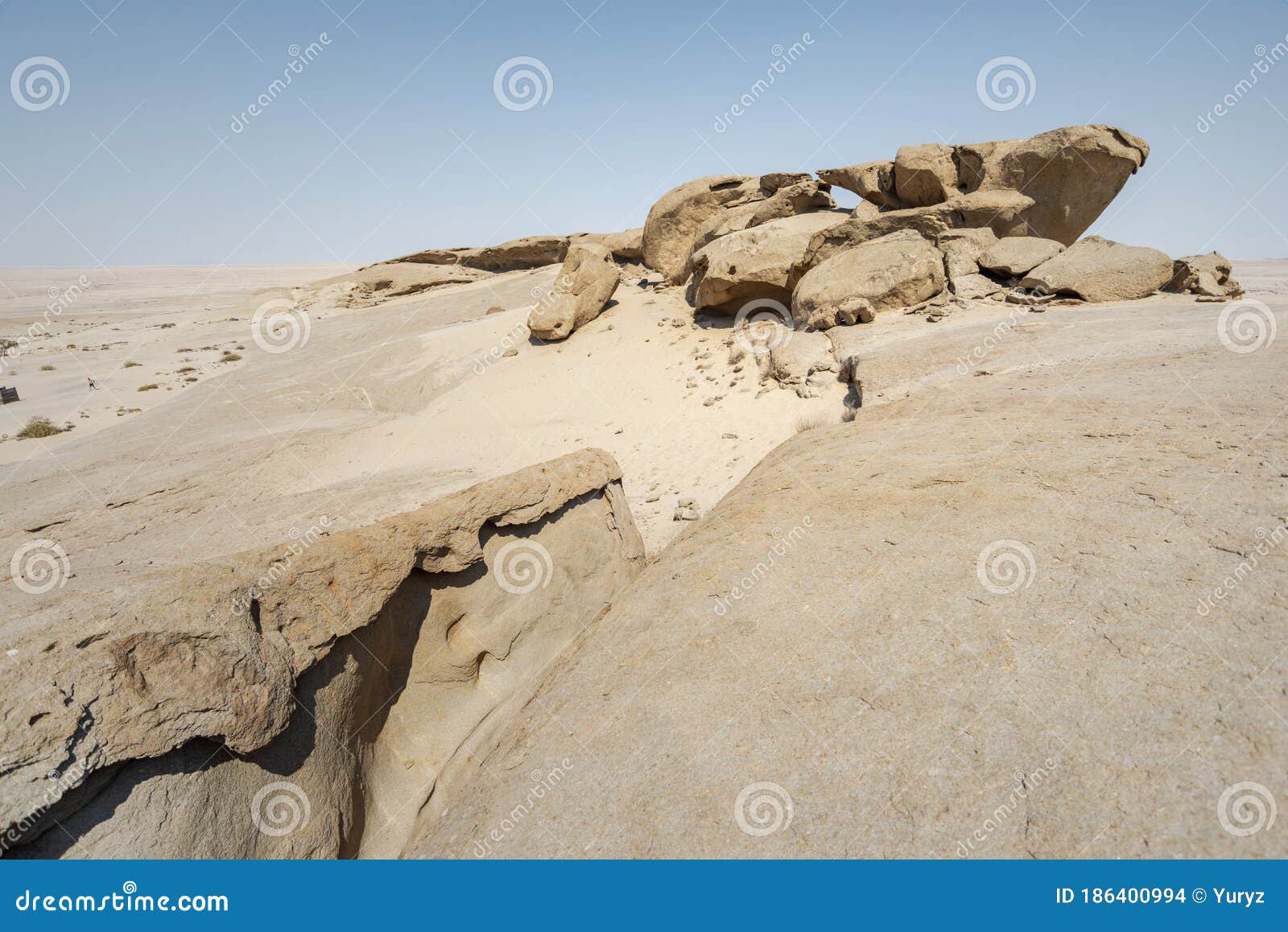 Weathered rocks in desert stock photo. Image of volcanic - 186400994
