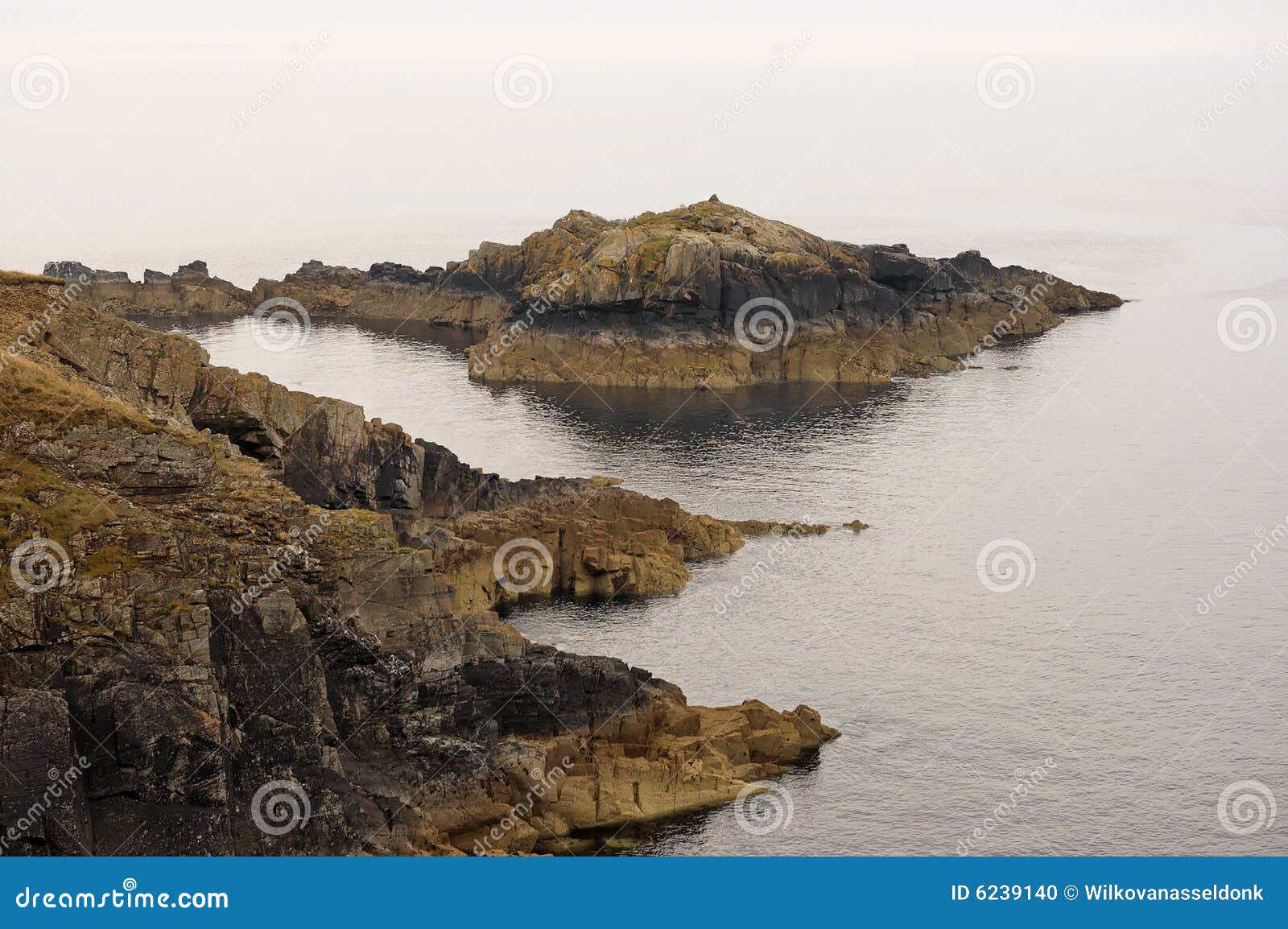 Weathered Rocks Stretching Out In The Sea Picture. Image: 6239140