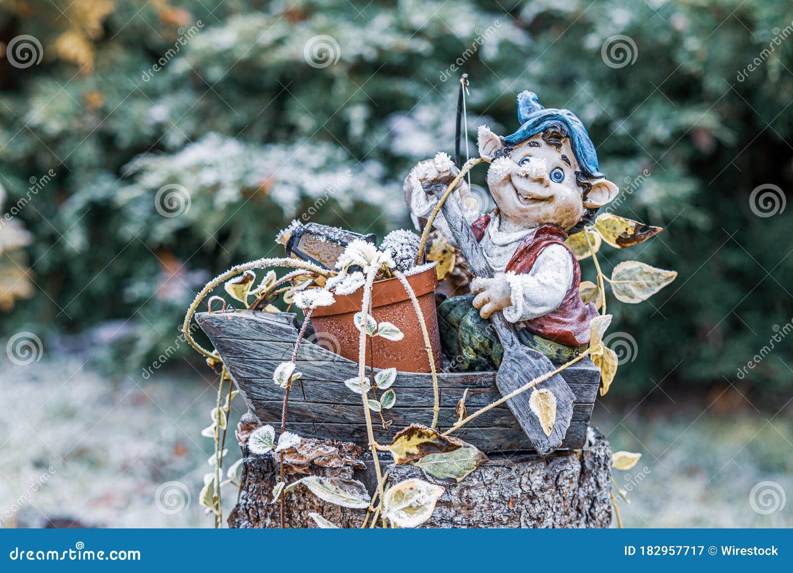 Weathered Troll Statue and a Flower Pot in a Wooden Rusty Boat ...