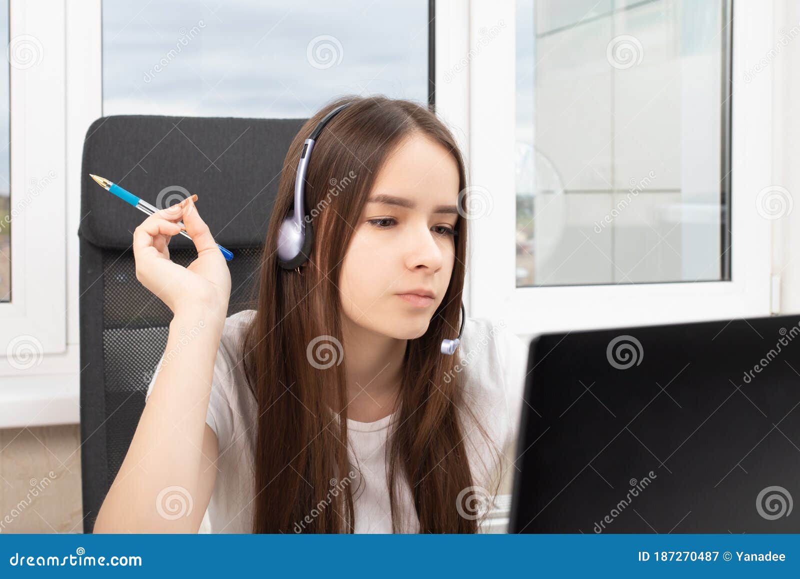 Webinar Online. a Student at Home is Studying with Headphones with a ...