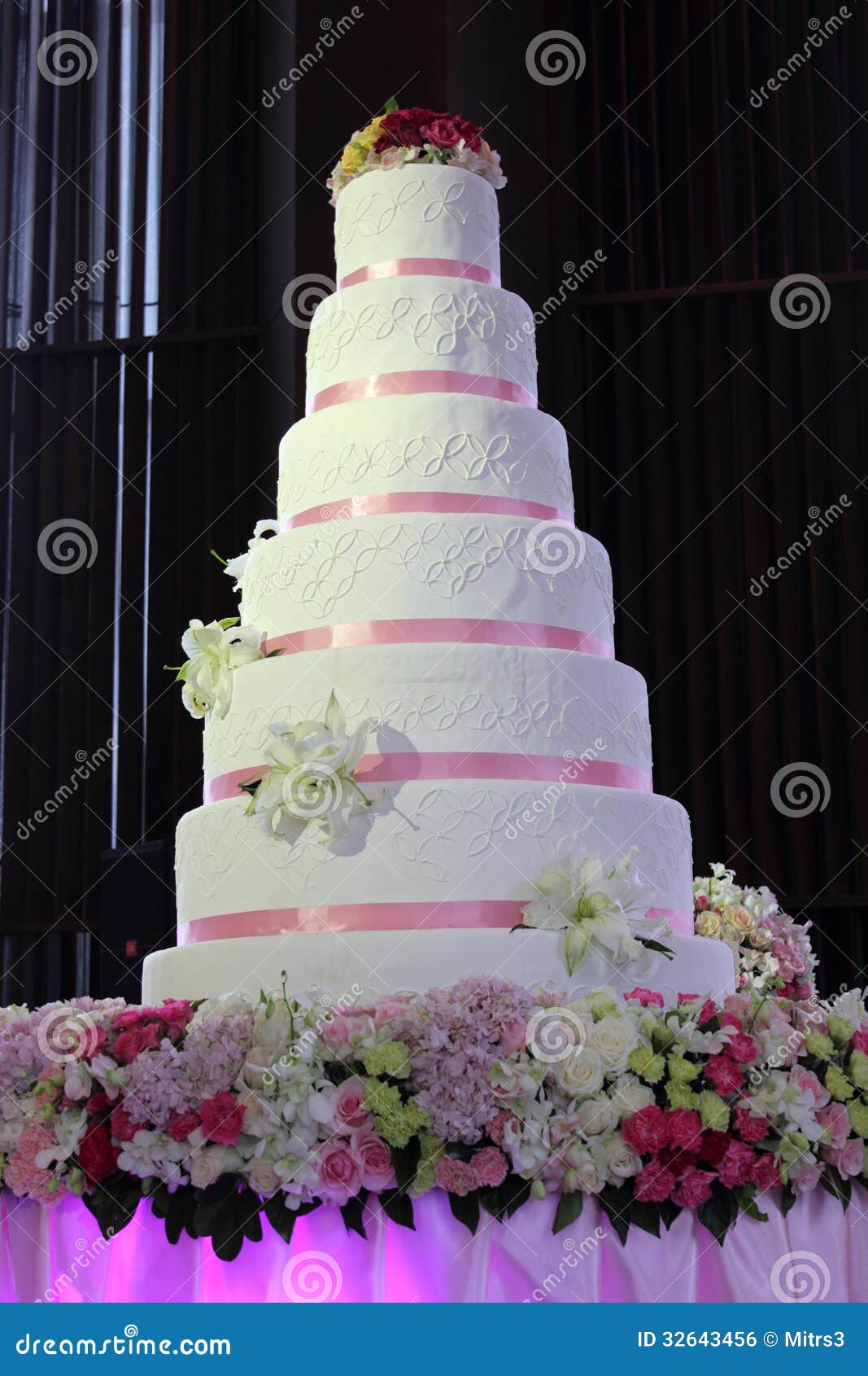 Wedding Cake with Pink Ribbon and Flowers Stock Photo - Image of table ...