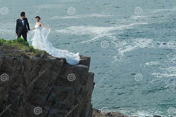 Wedding couple at cliff stock photo. Image of landscape - 26627614