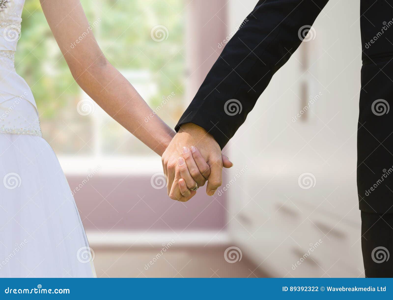 Wedding Couple Holding Hands Near Window Stock Photo - Image of lens ...