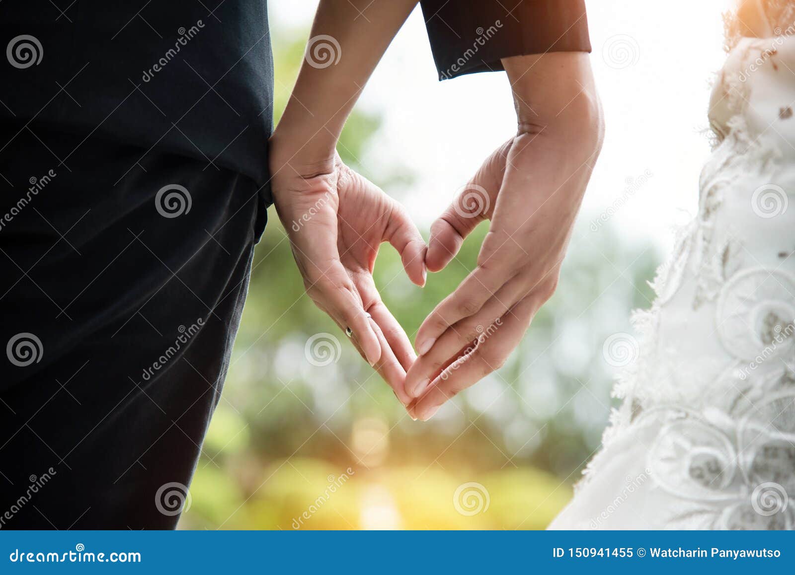 The Wedding Couple Is Making Love Hand Sign Together Heart Sign By Hand