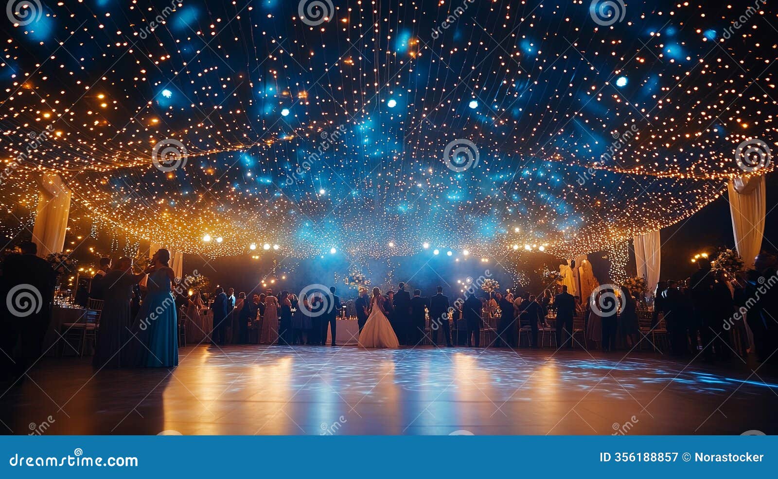 A Wedding Reception Dance Floor Under a Canopy of String Lights and ...