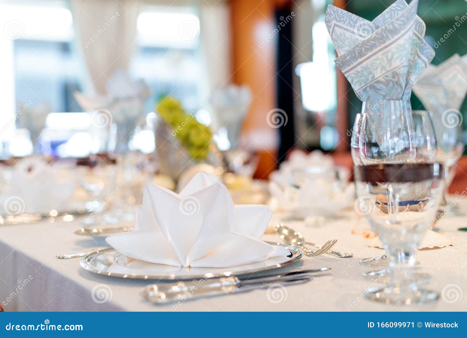 Wedding Reception Table Setting with Champagne Glasses and Napkins on ...