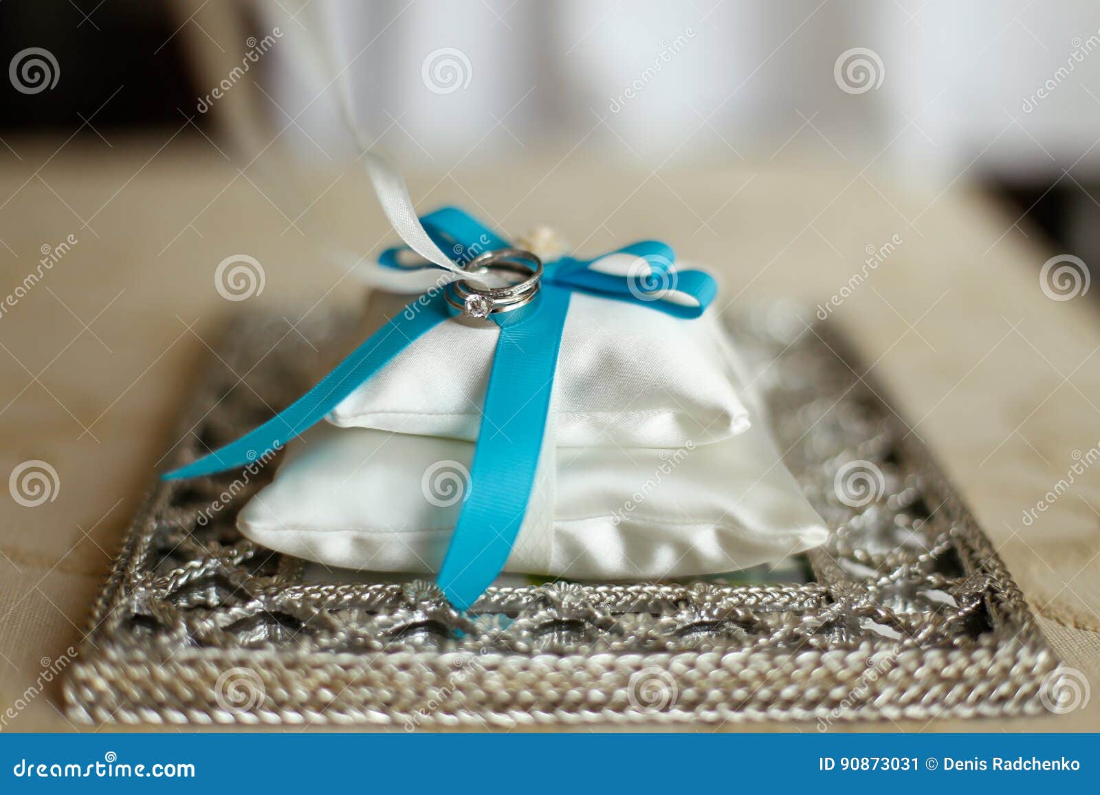 Wedding Rings on a Cushion with Blue Ribbon Stock Image - Image of ...