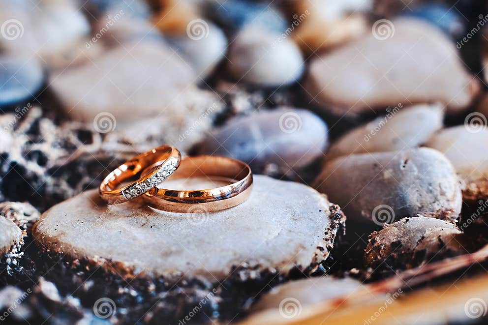 Wedding Rings with a Diamond Lie on a Stone Stock Photo - Image of ...