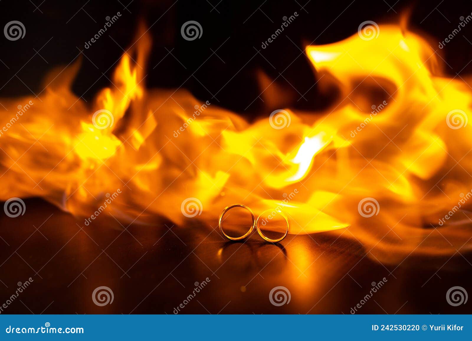 Wedding Rings on Fire with Reflection. Selective Focus. a Stream of ...