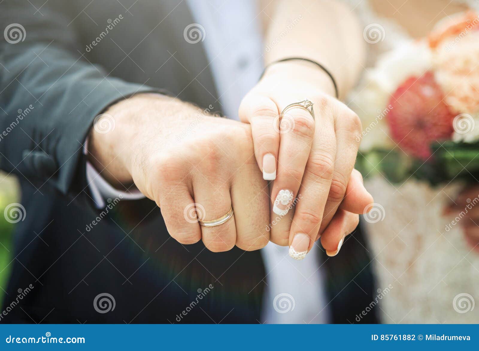 Wedding Rings and the Hands of the Groom and the Bride Stock Photo ...