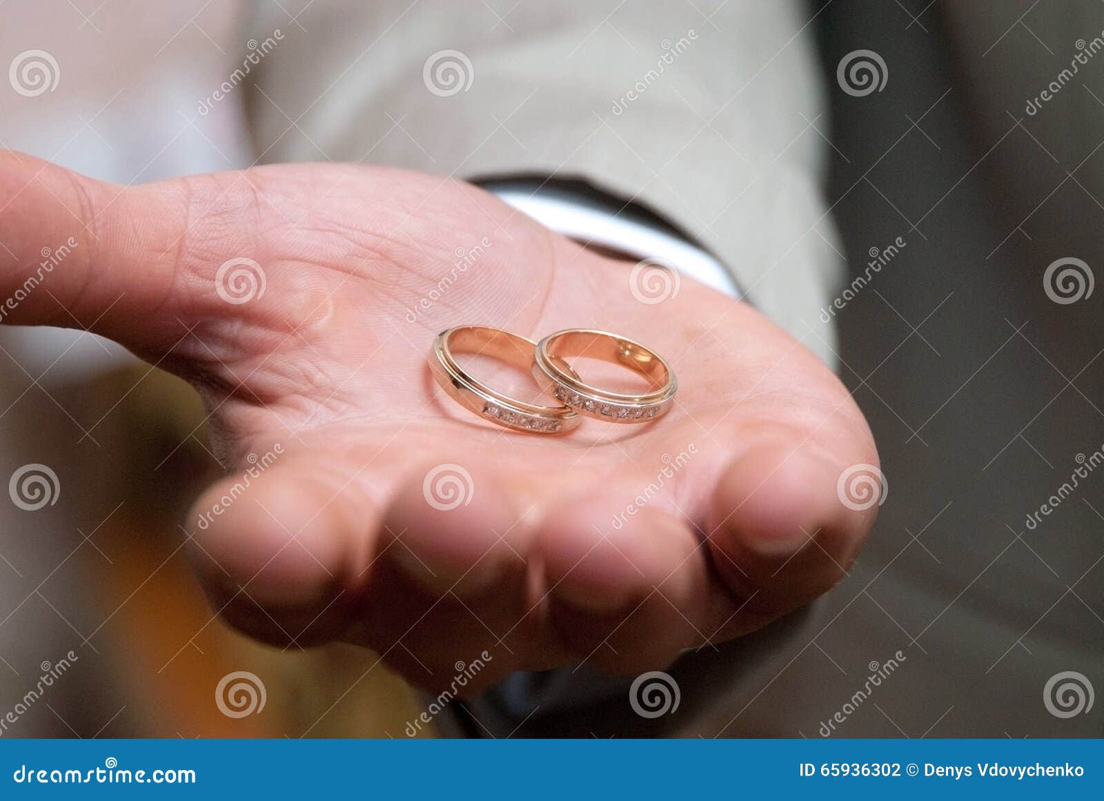 Wedding rings in man hand stock photo. Image of hand - 65936302
