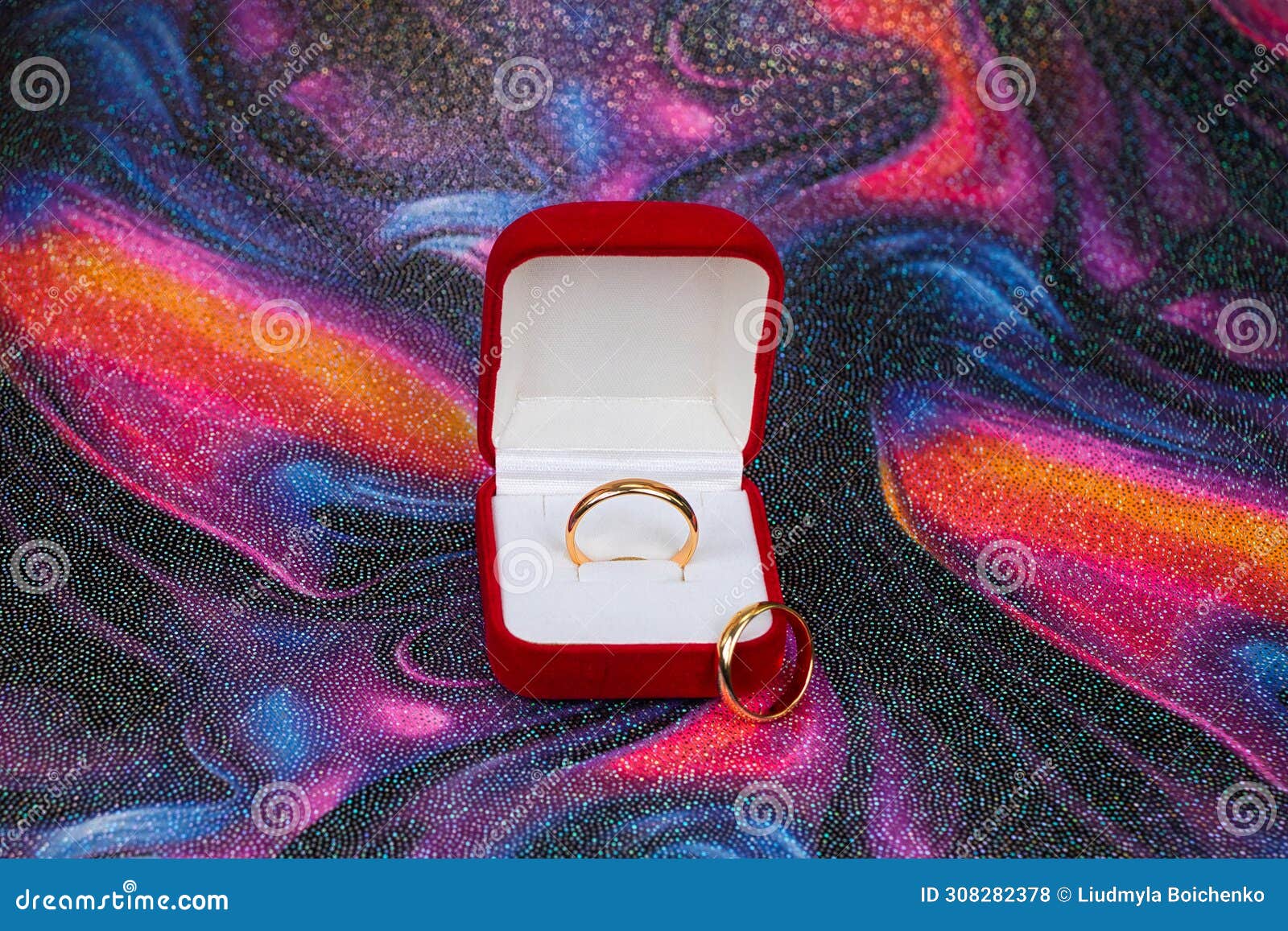 Wedding Rings in a Red Box on a Multicolored Background Stock Photo ...