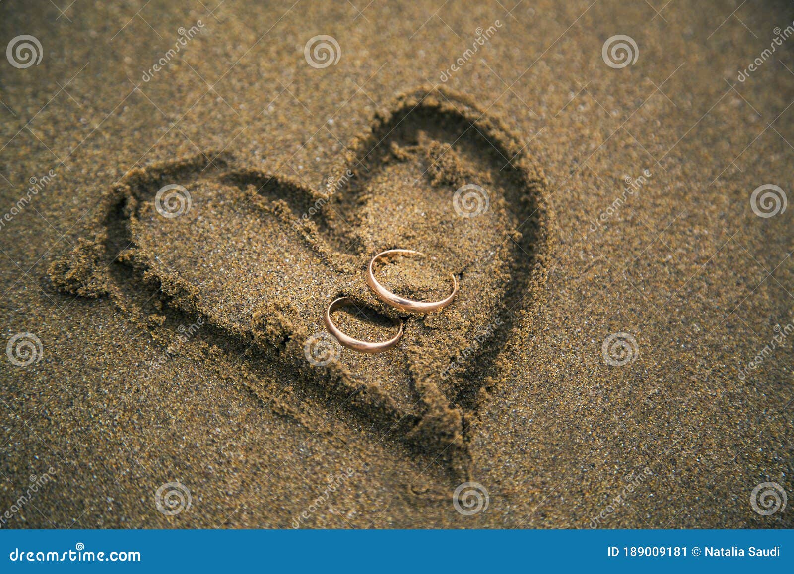 Wedding rings in the sand stock image. Image of pair - 189009181