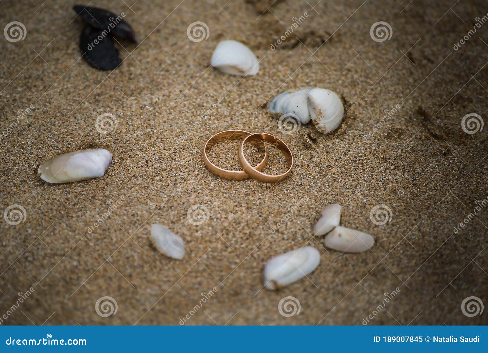 Wedding rings in the sand stock image. Image of closeup - 189007845