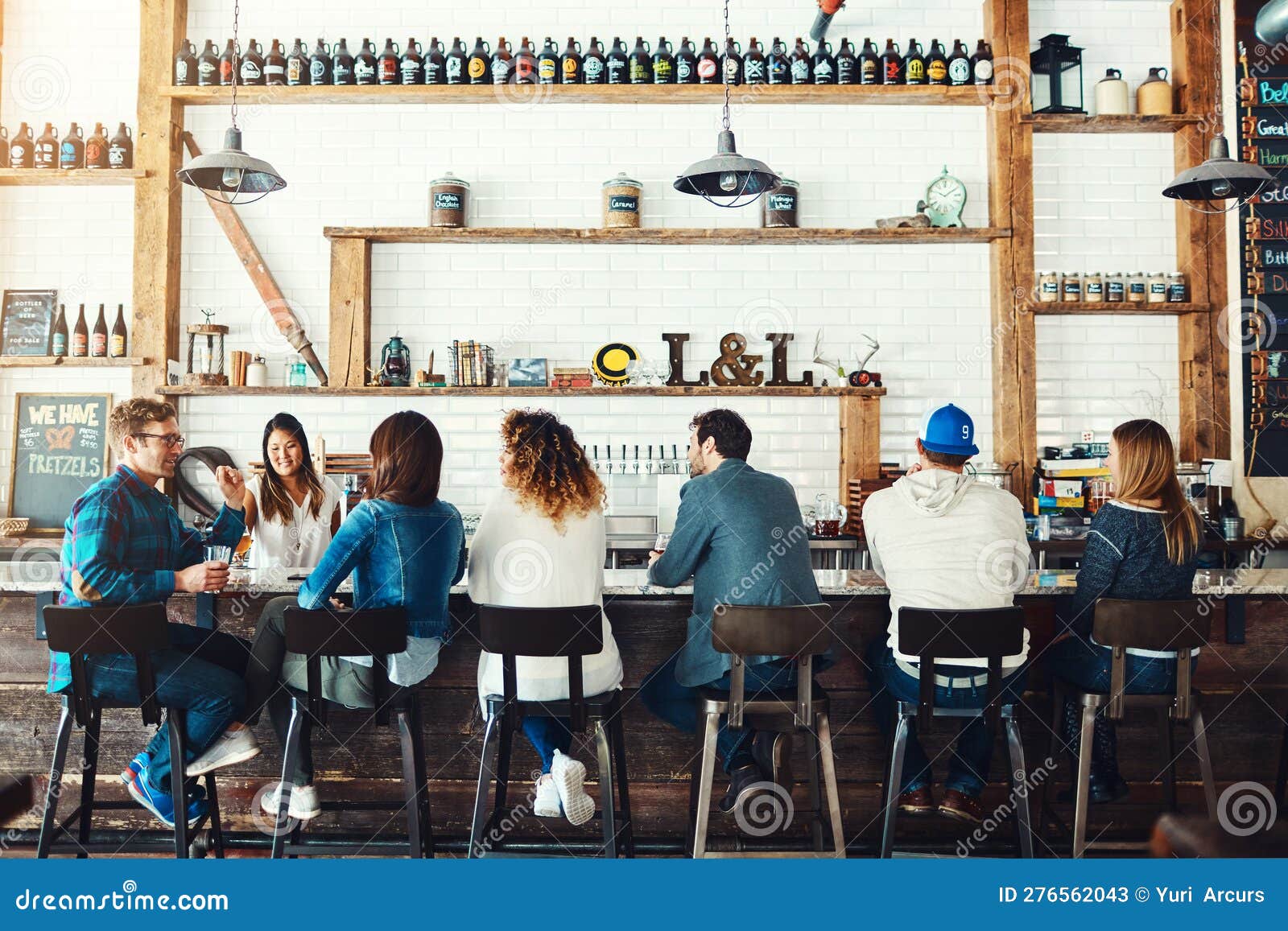 The Weekend is Finally Here. Rearview Shot of People Drinking at a Bar ...