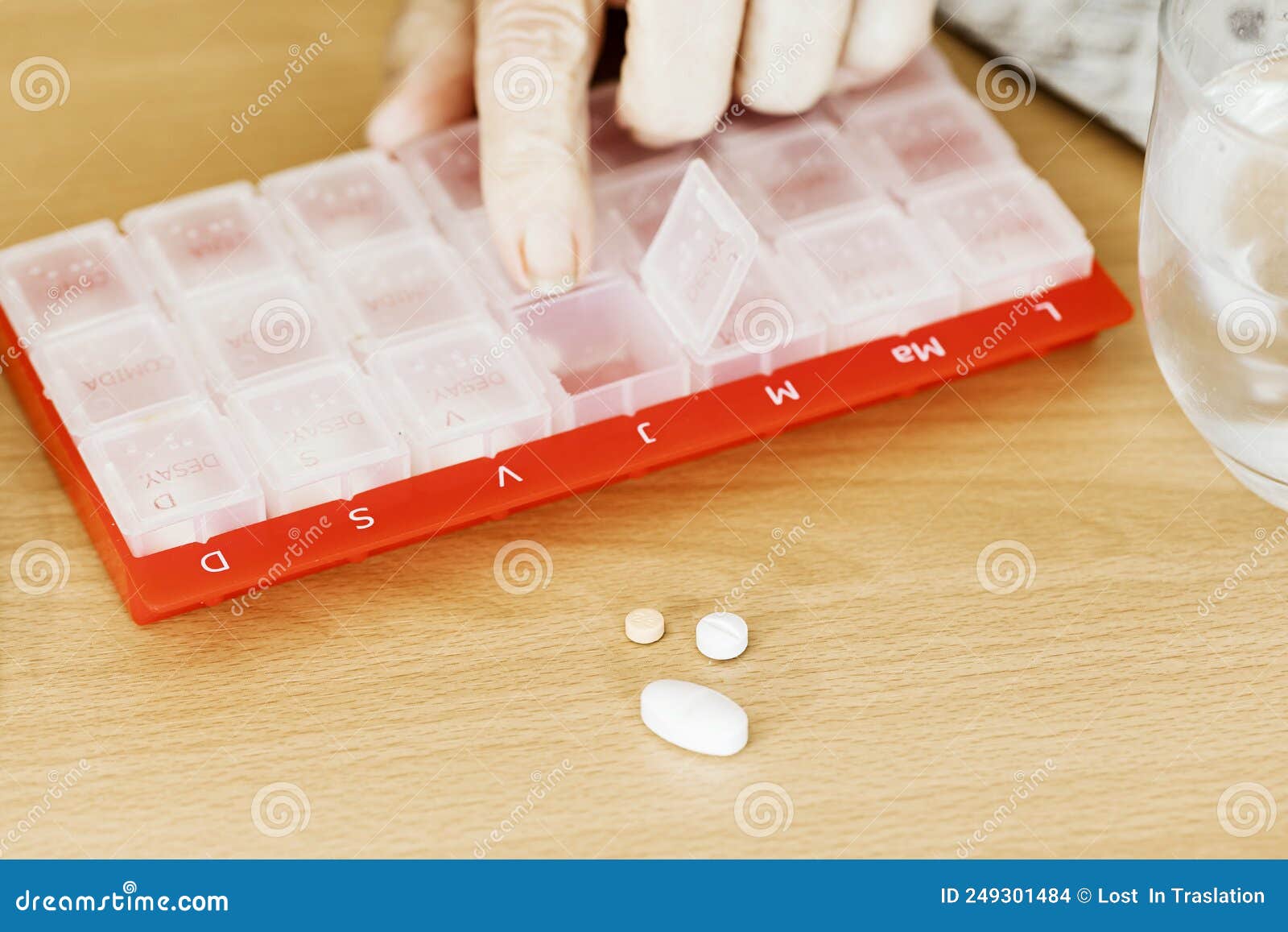 Weekly Pillbox with Red Medication Stock Photo - Image of hand, elderly ...