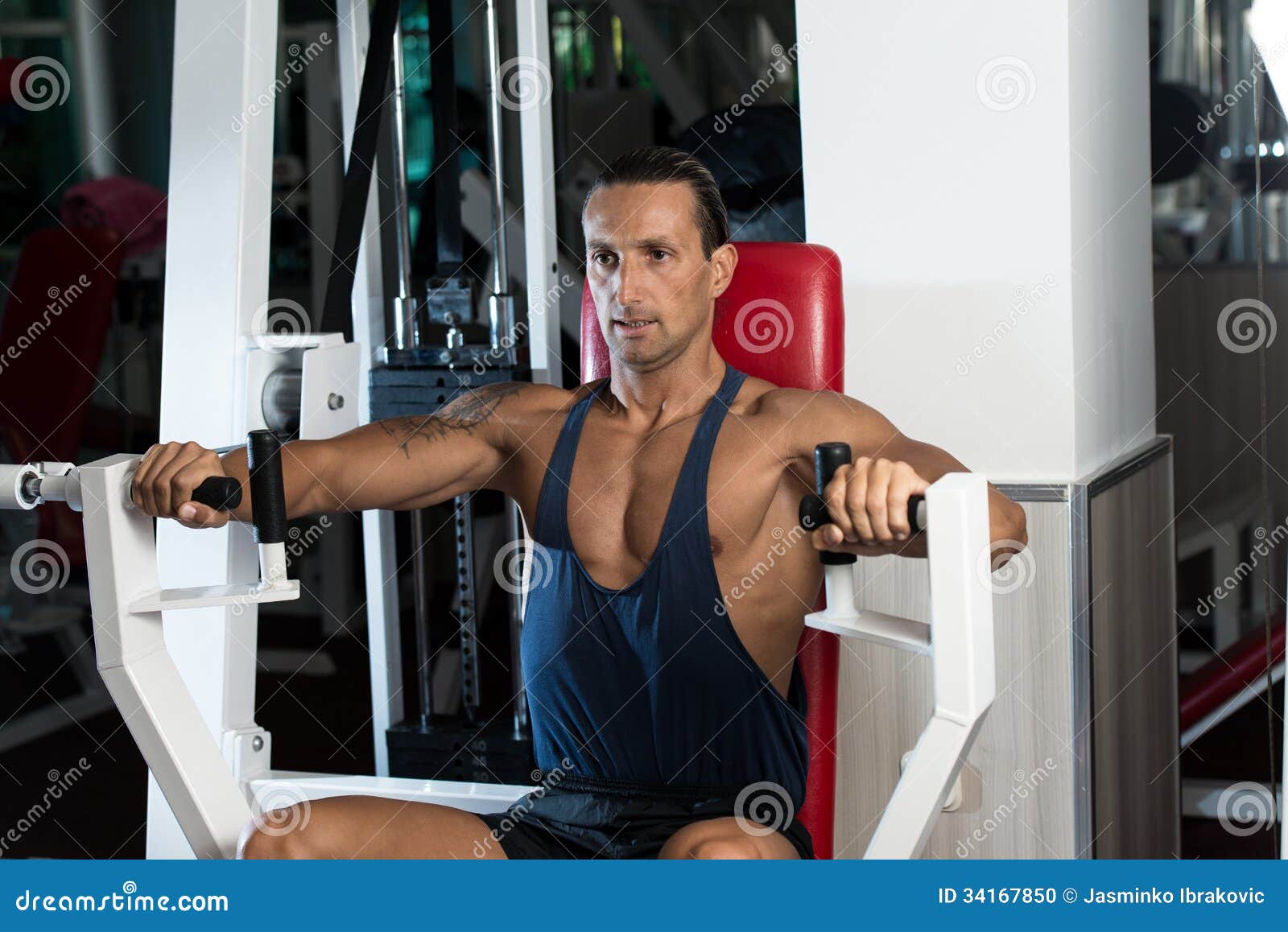 Weightlifter on Exercise Machine Stock Photo - Image of muscular, blue ...