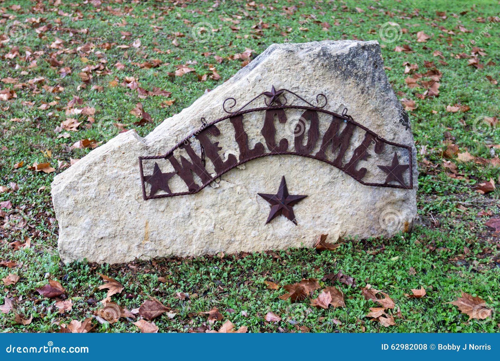 Welcome Sign on a Rock stock photo. Image of stars, antique - 62982008