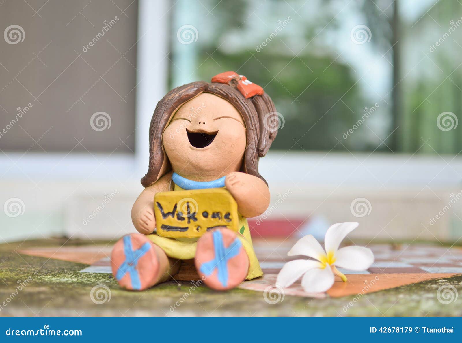 Welcome Sign Stone Doll with White Flower on the Table Stock Image ...