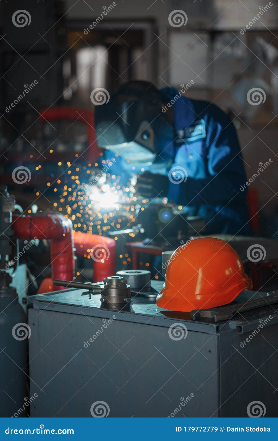 Welder, Bright Sparks from Welding in the Dark. Construction Helmet in ...