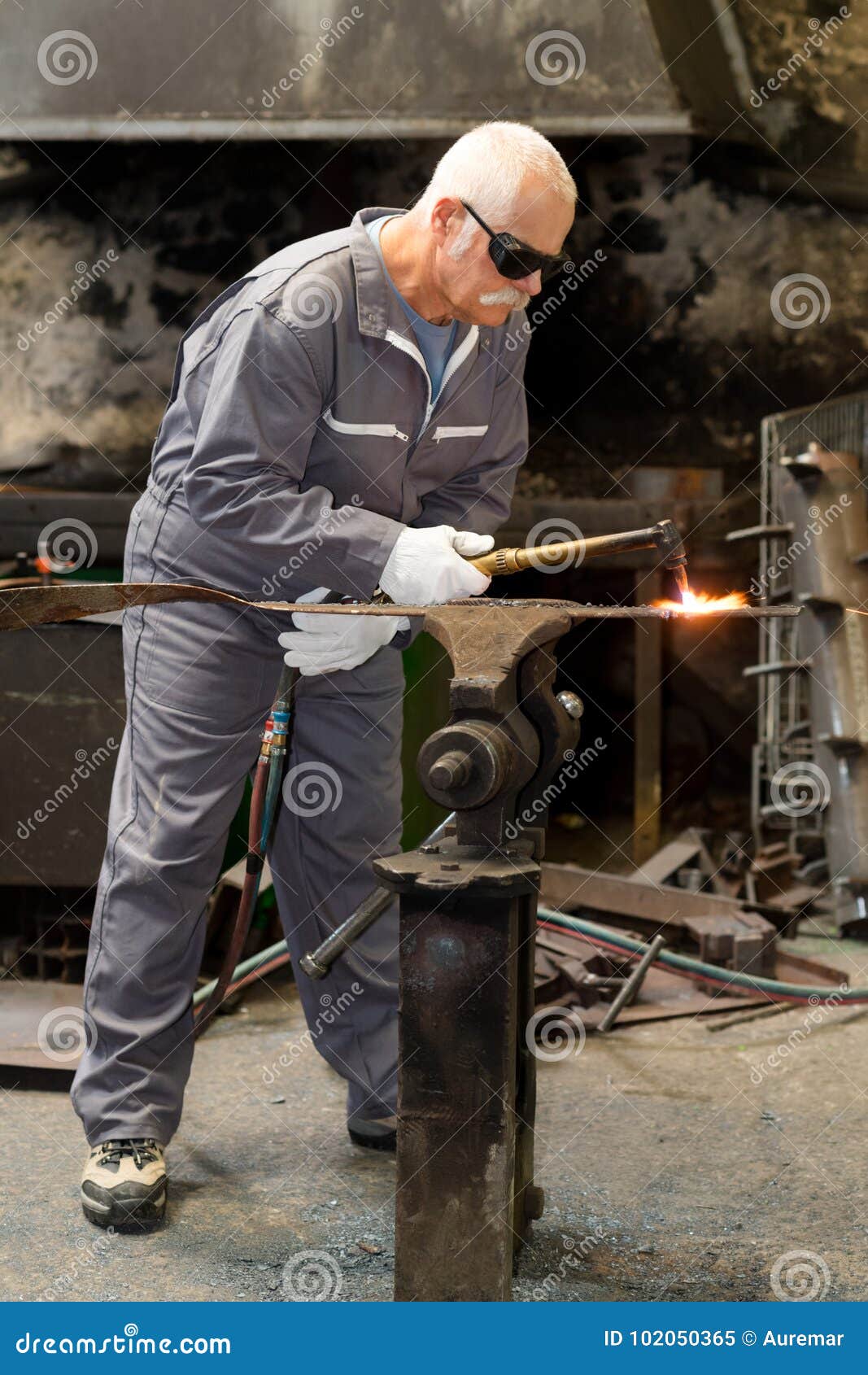 A Welder Busy Welding On A Motor Vehicle Production Line With A Big ...