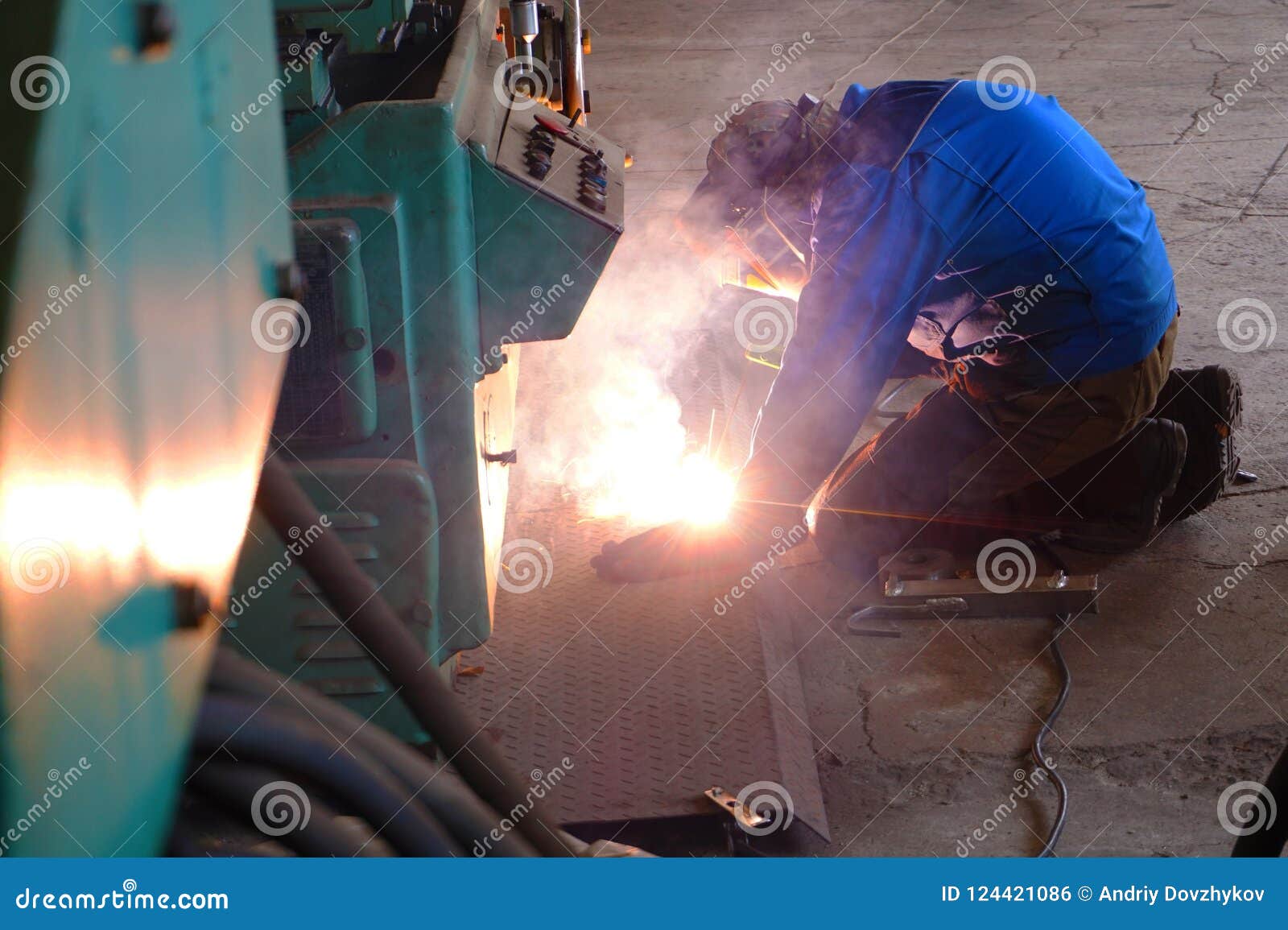 The Welder at the Industrial Plant Makes the Connection Using an ...