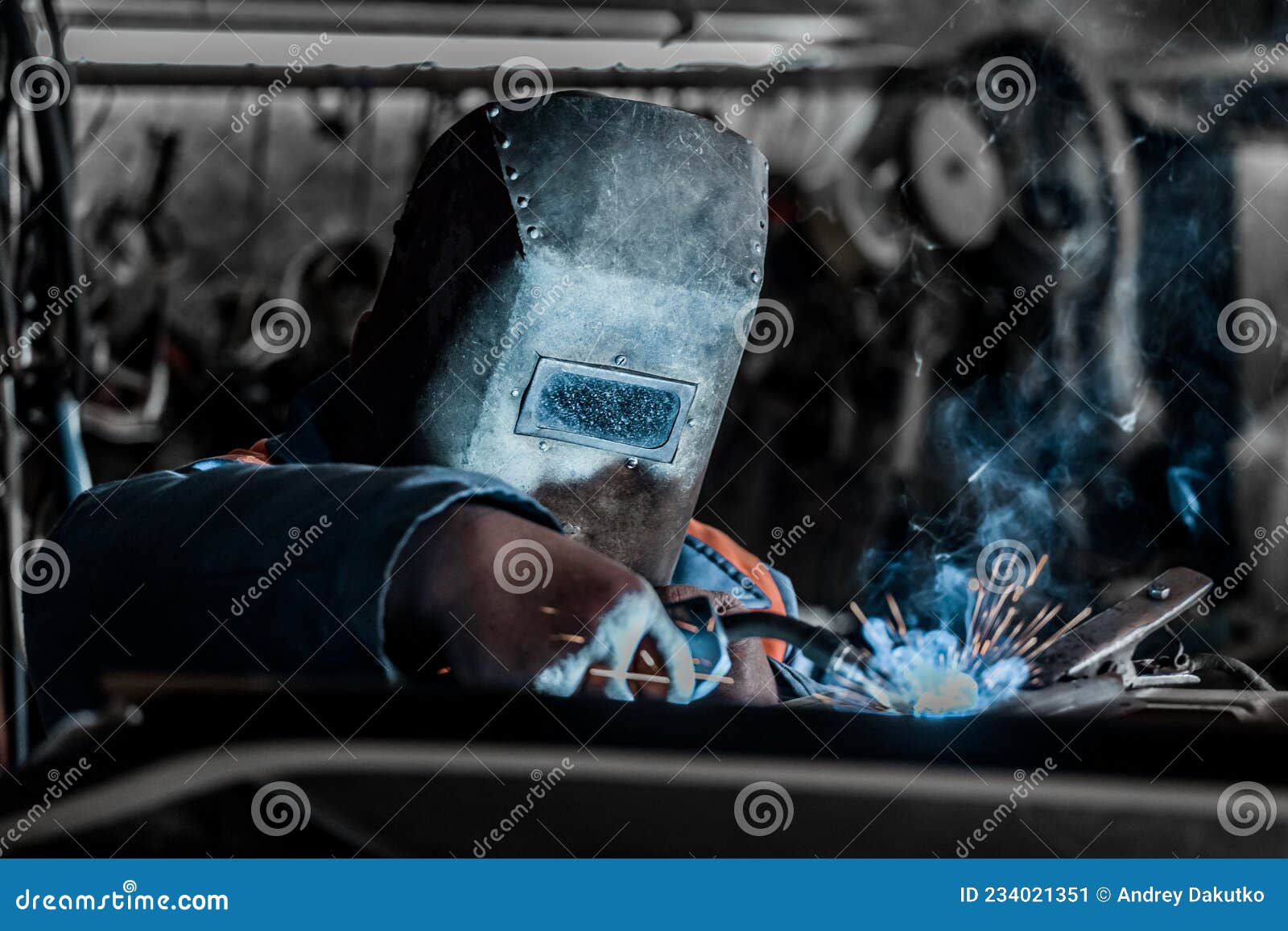 Welder Industrial Worker in the Protective Shield is Engaged in Welding ...