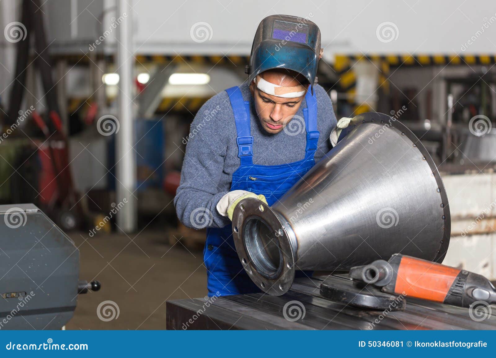 Welder Inspecting Metal Piece for Quality Control Stock Image - Image ...