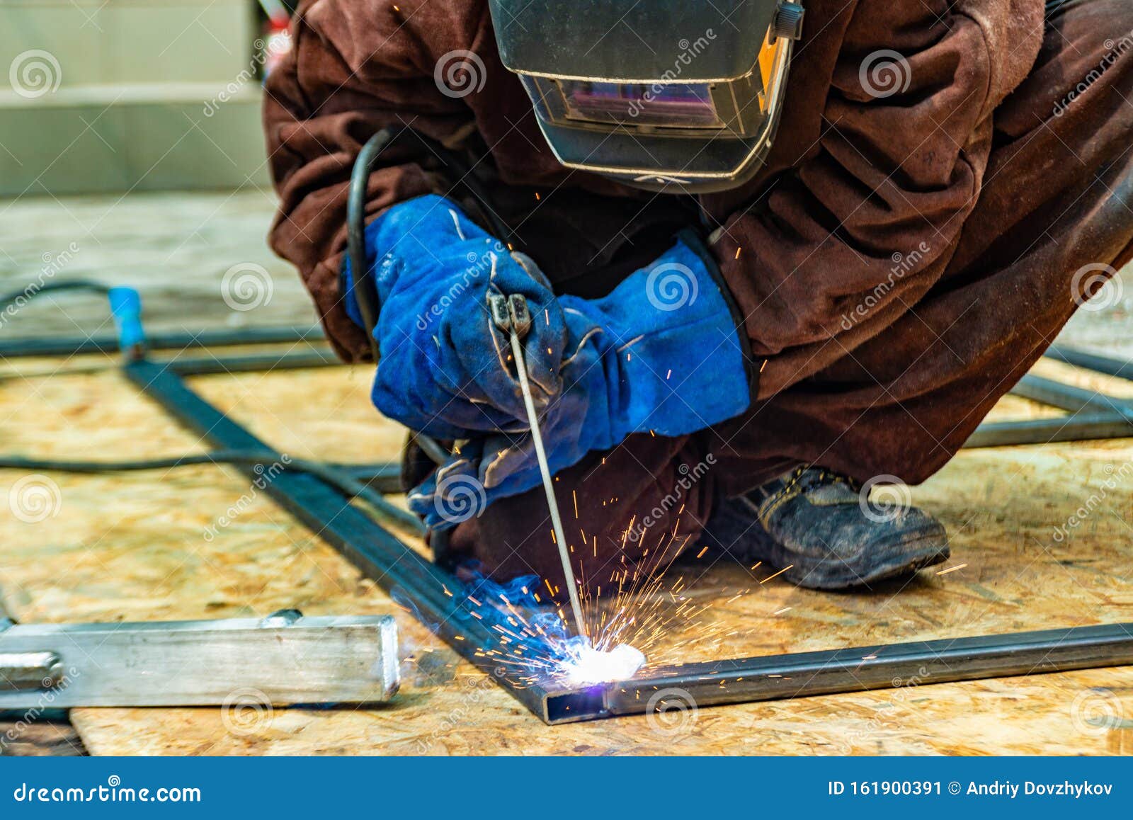 A Welder Makes a Frame from a Profile Pipe by Connecting Them with ...