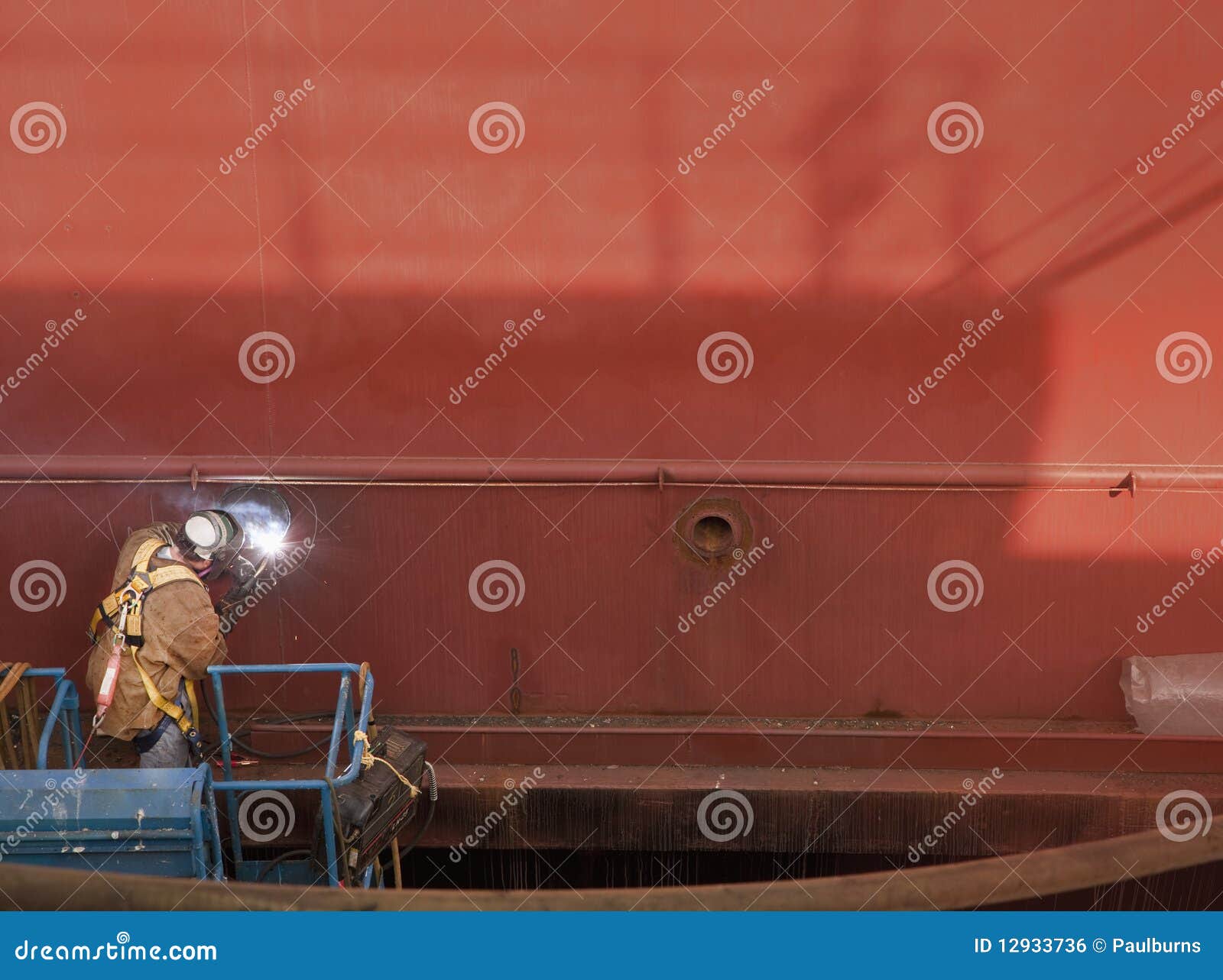 Welder in Man Lift Welding on Ship Hull Stock Photo - Image of welder ...