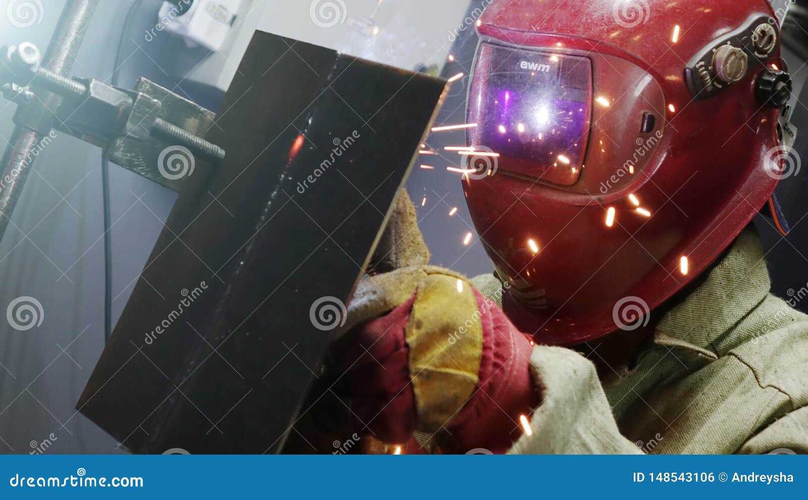 Welder in the Mask. the Metal Product is Welded by Welding Machine ...