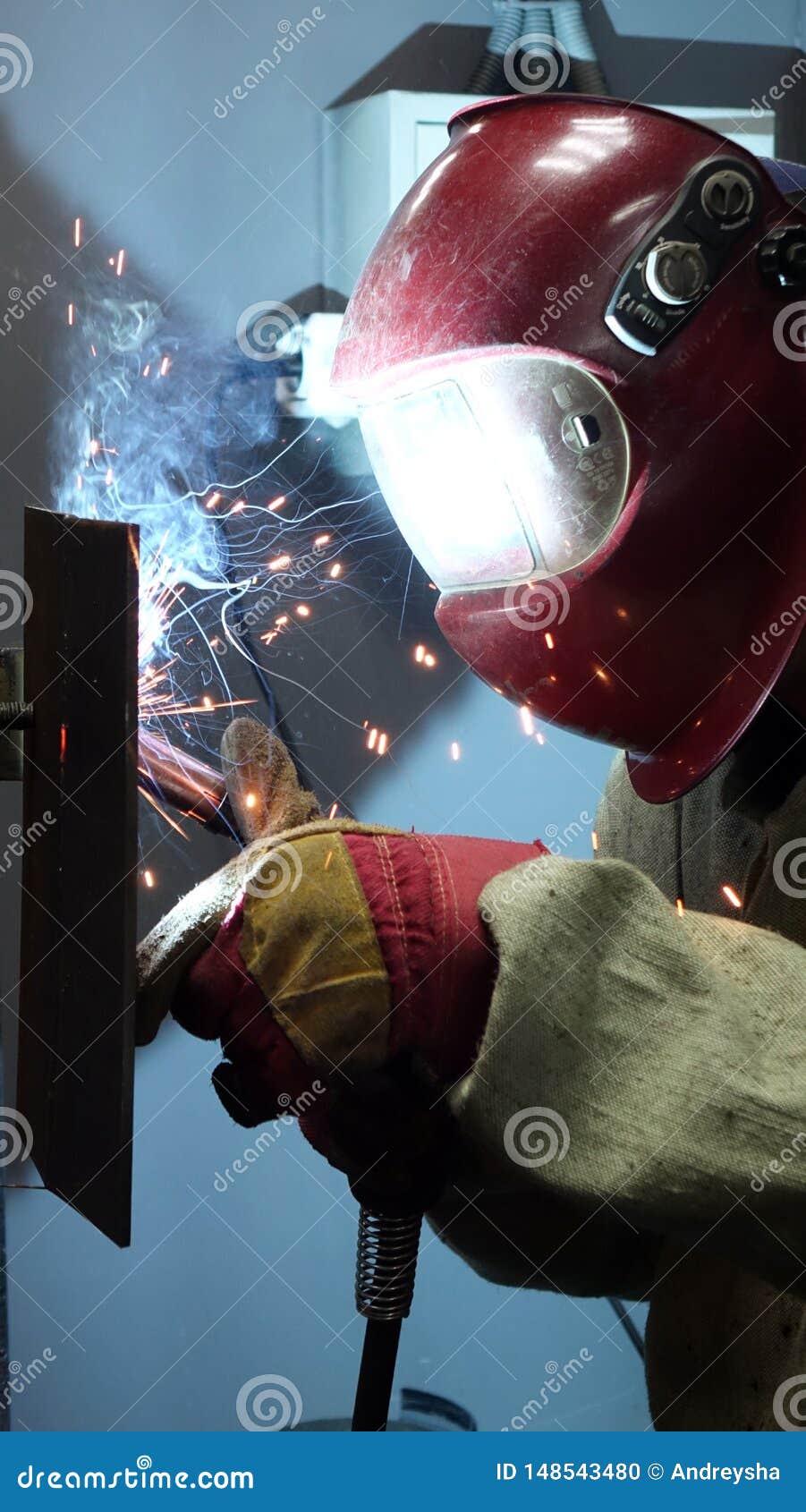 Welder in the Mask. the Metal Product is Welded by Welding Machine ...