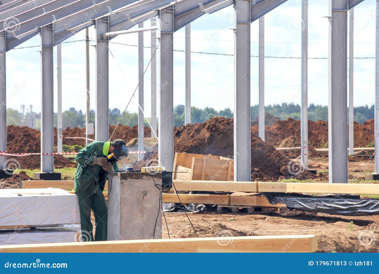 The Welder in a Protective Mask at Work. Welding in Construction Stock ...
