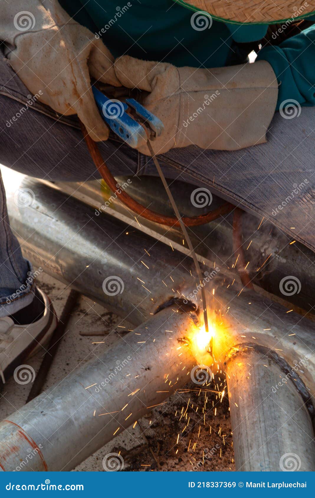 The Welder is Sitting on the Steel Roof Frame and is Welding. Stock ...