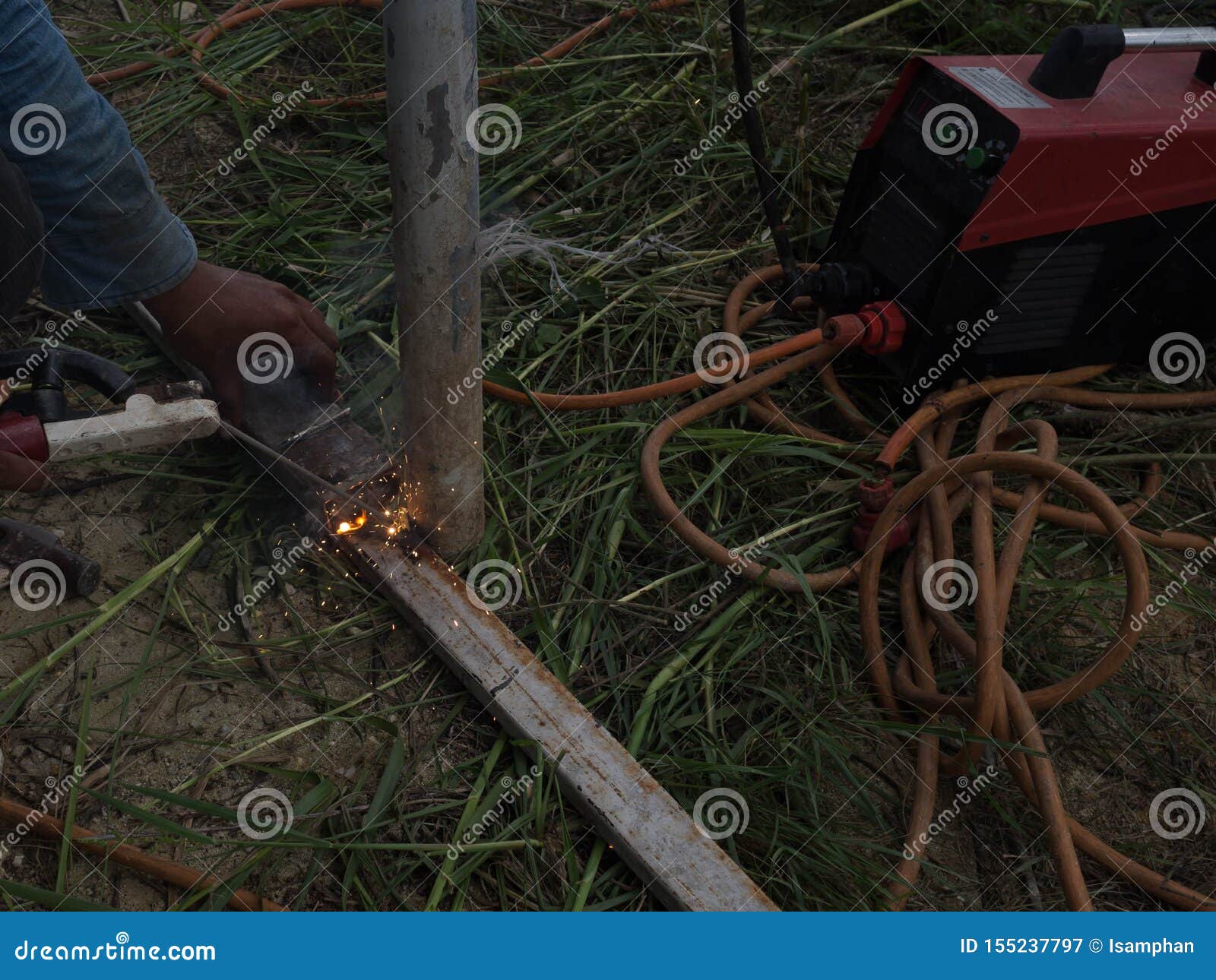 The Welder Using Electrode Welding the Steel Frame with Welding Machine ...