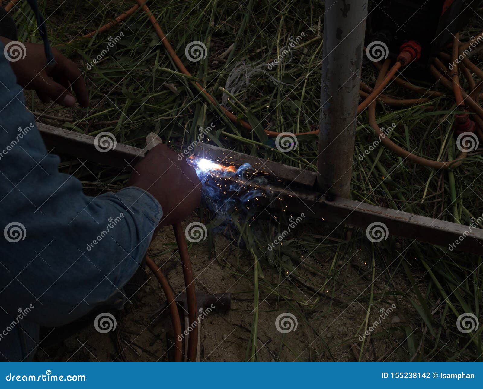 The Welder Using Electrode Welding the Steel Frame with Welding Machine ...