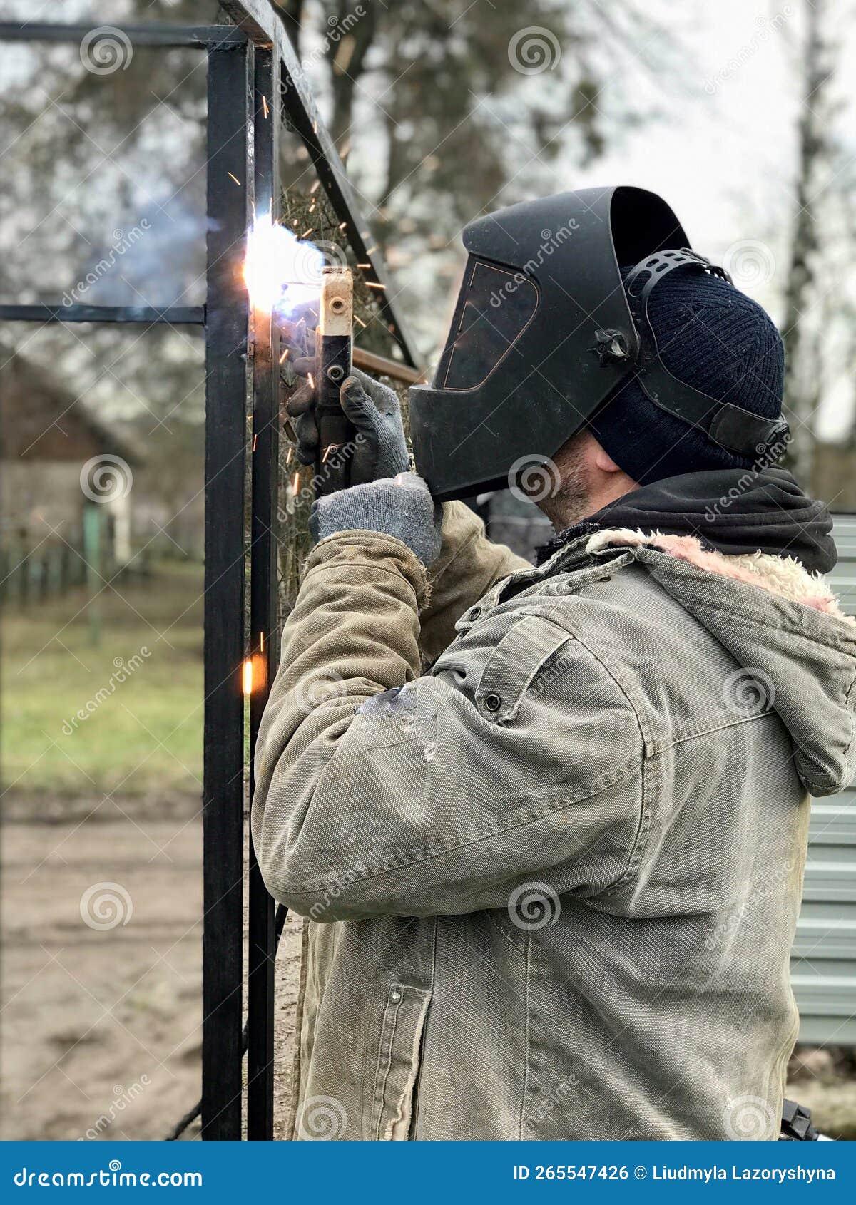 A Welder Welds a Fence on the Street Stock Photo - Image of street ...