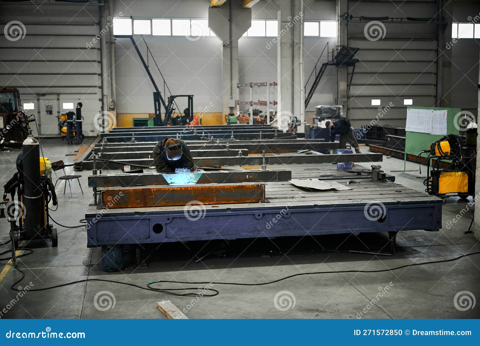 Welder during Work at Large Metal Carcass in Assembling Shop Stock ...