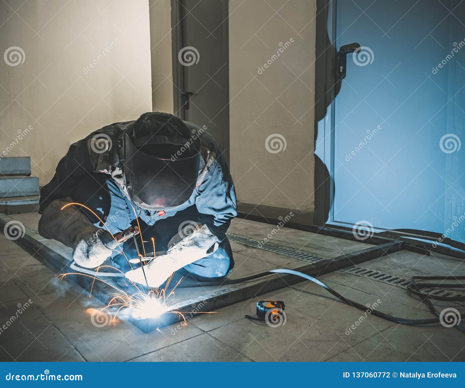 Welder Worker Performs Jump Welding. Worker Welder Performs Arc-Welding ...