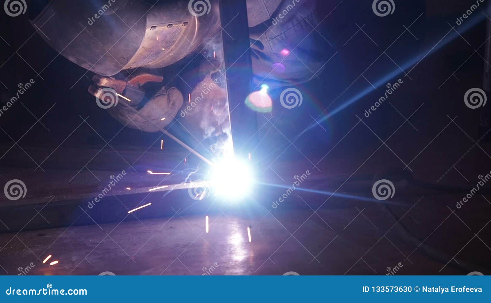 Welder Worker Performs Jump Welding. Worker Welder Performs Arc-Welding ...