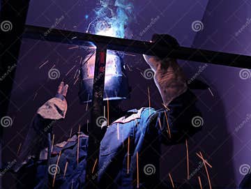 Welder Worker Performs Jump Welding. Worker Welder Performs Arc-Welding ...