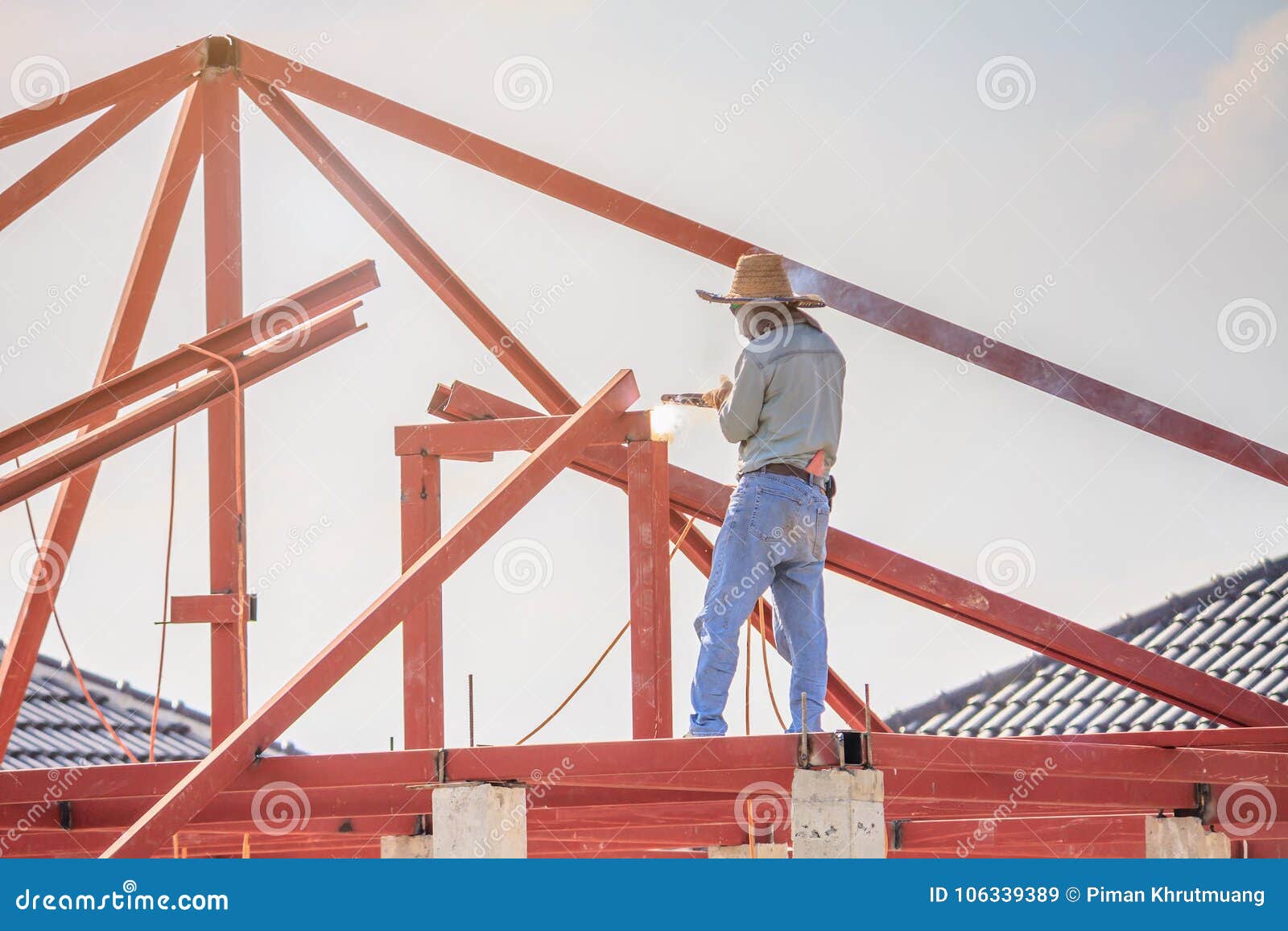 Welder Workers Installing Steel Frame Structure of the House Stock ...