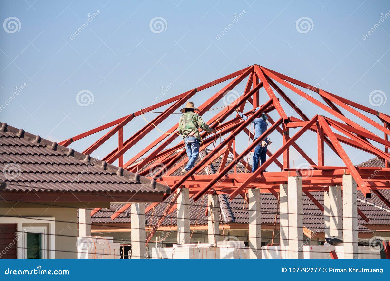 Welder Workers Installing Steel Frame Structure of the House Stock ...