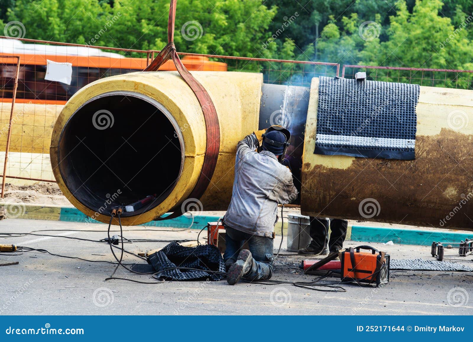 A Welder Works with a Large Diameter Pipe at a Construction Site ...