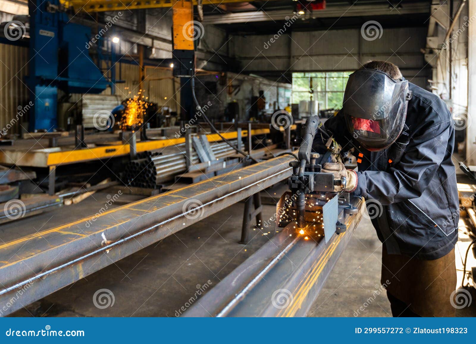 The Welder Works in the Workshop. the Moment of Welding of Metal ...