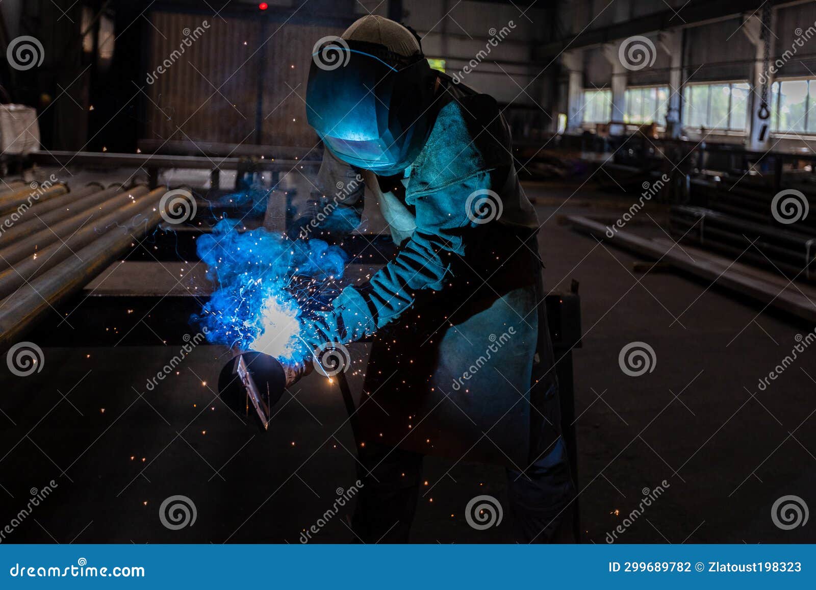 The Welder Works in the Workshop. the Moment of Welding of Metal ...
