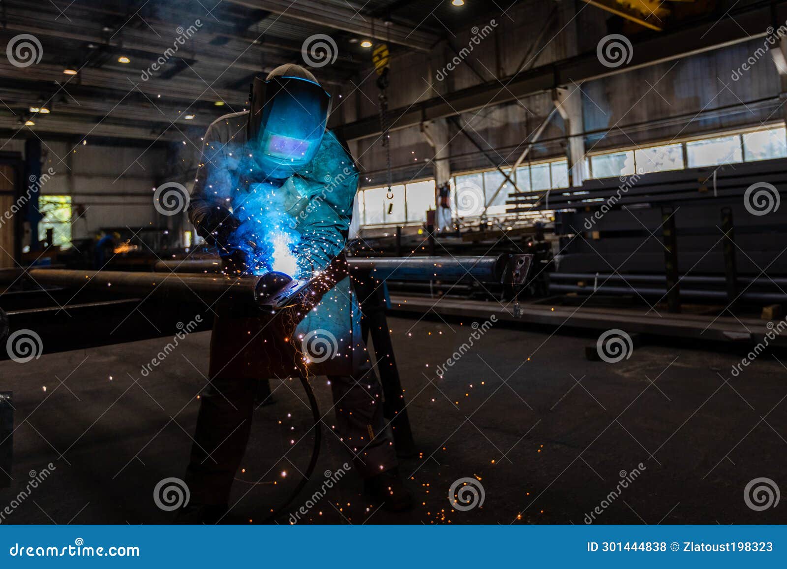 The Welder Works in the Workshop. the Moment of Welding of Metal ...