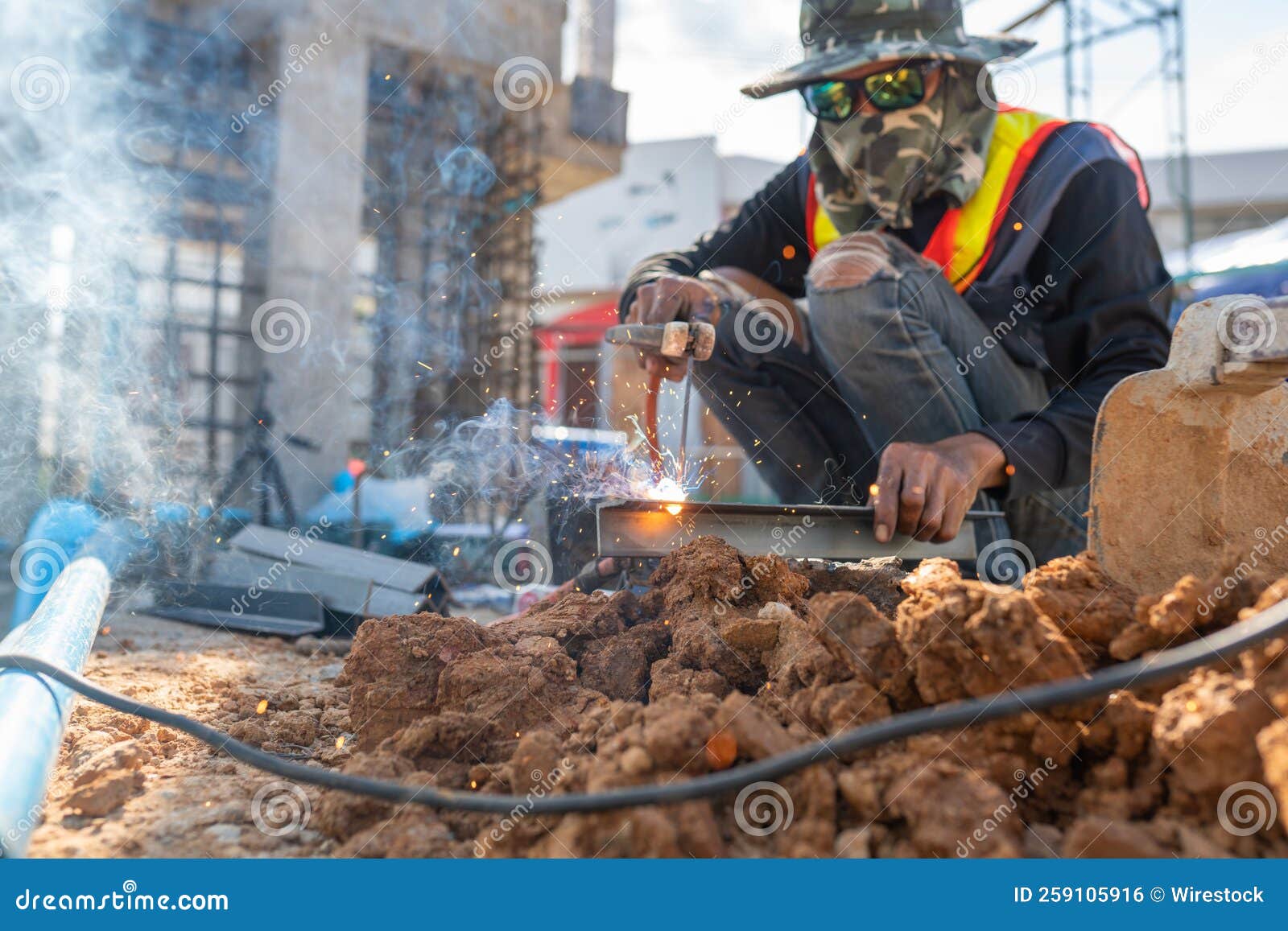 Welding Worker Man in the Construction Site in Uniform Safety Stock ...
