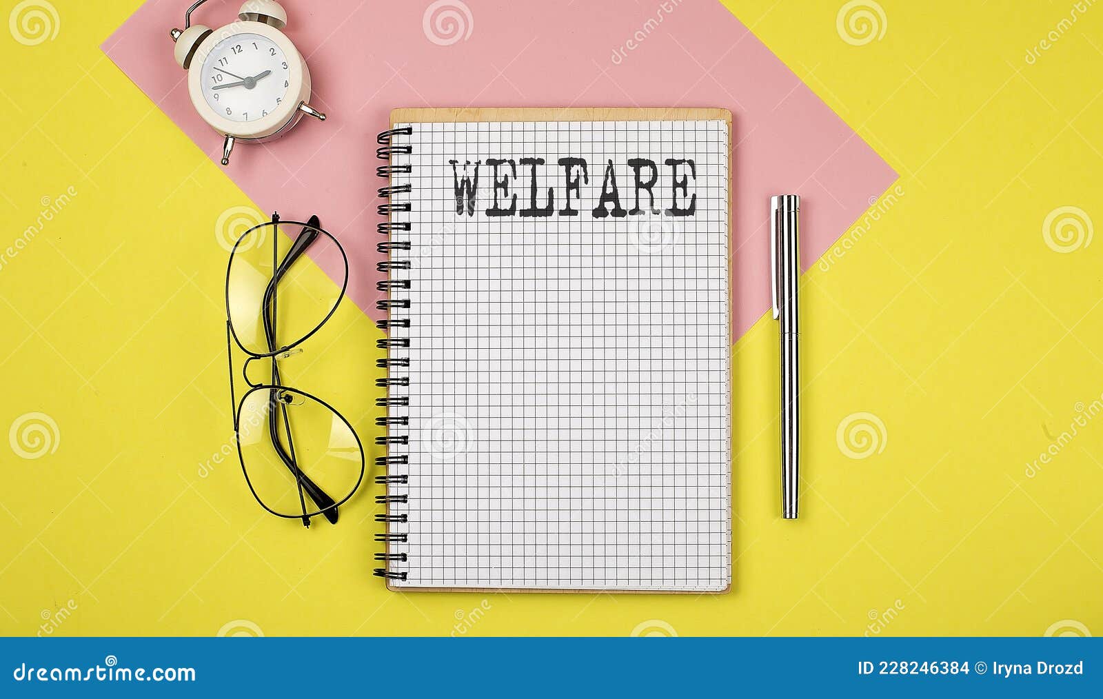 WELFARE Notice on the Notepad with Pen, Glasses and Alarm Clock Stock ...