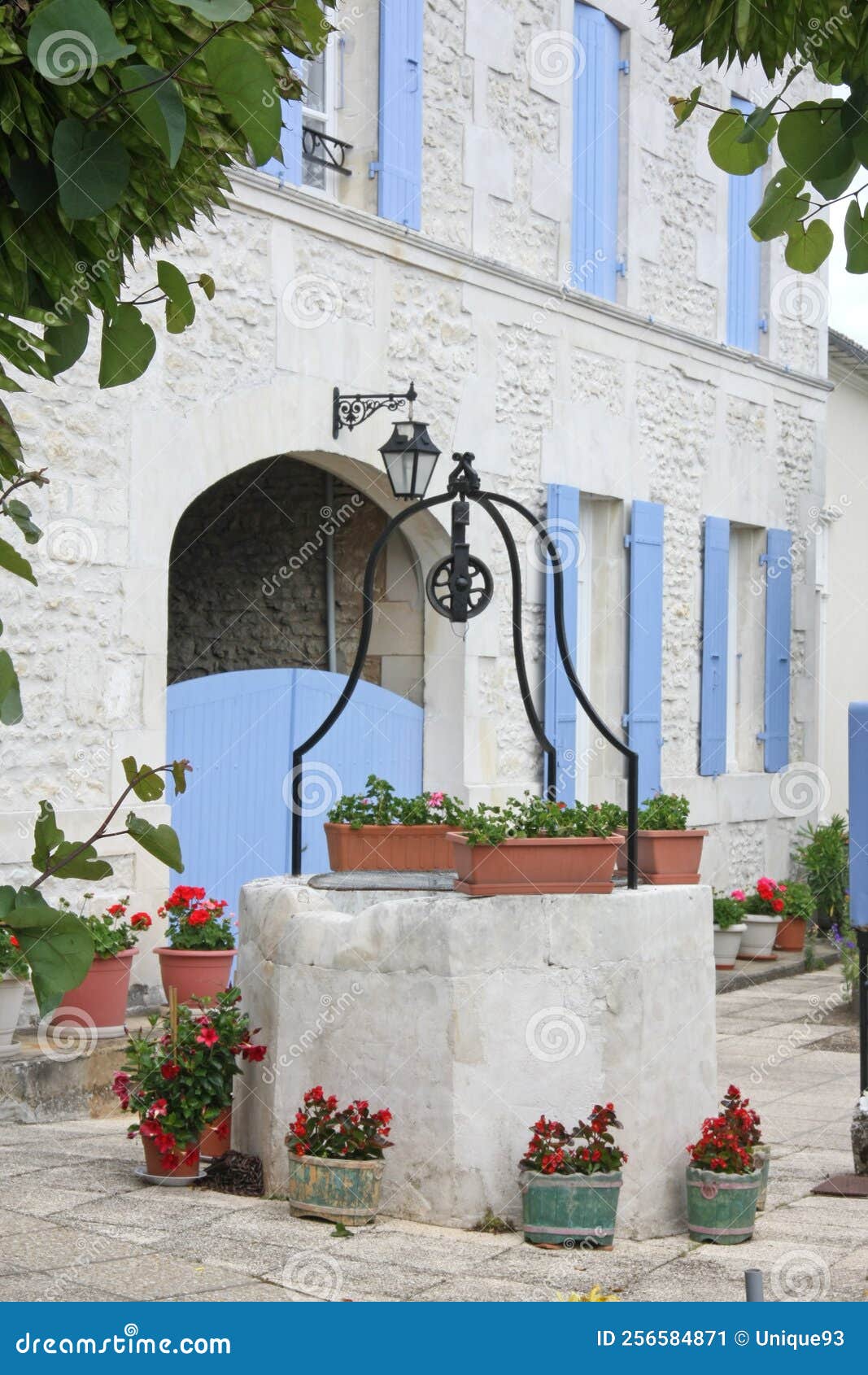Well in the Courtyard of an Old House Decorated with Flower Boxes Stock ...